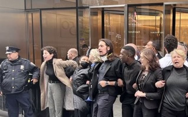 activists-link-arms-in-front-of-a-building – ScheerPost